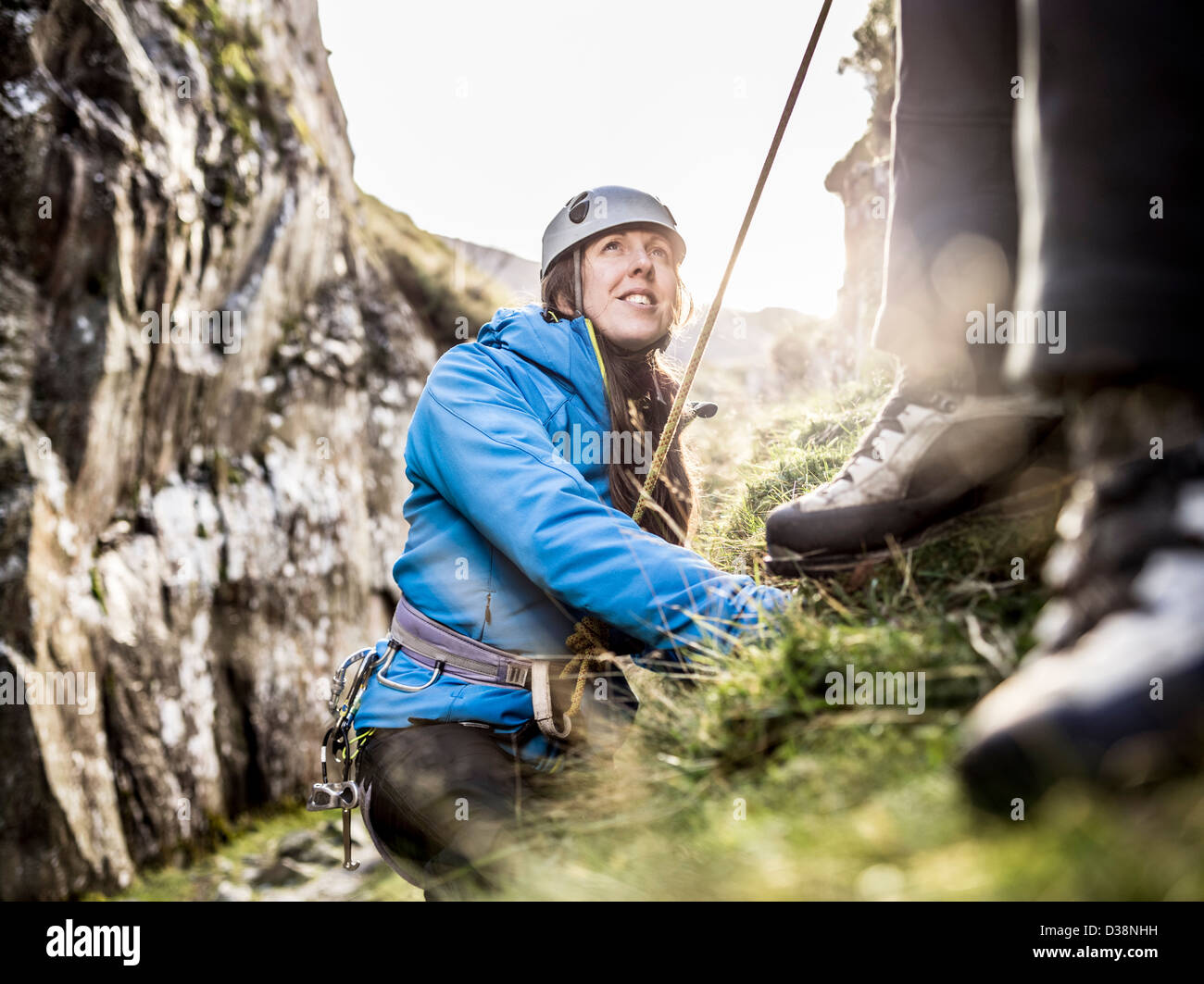 Rock climber scaling steep rock face Stock Photo - Alamy