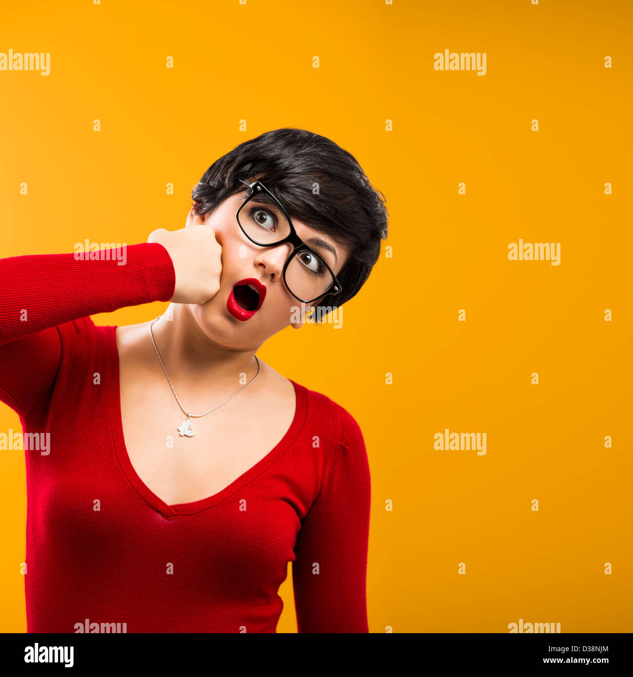 Nerd girl punching himself, against a yellow background Stock Photo - Alamy
