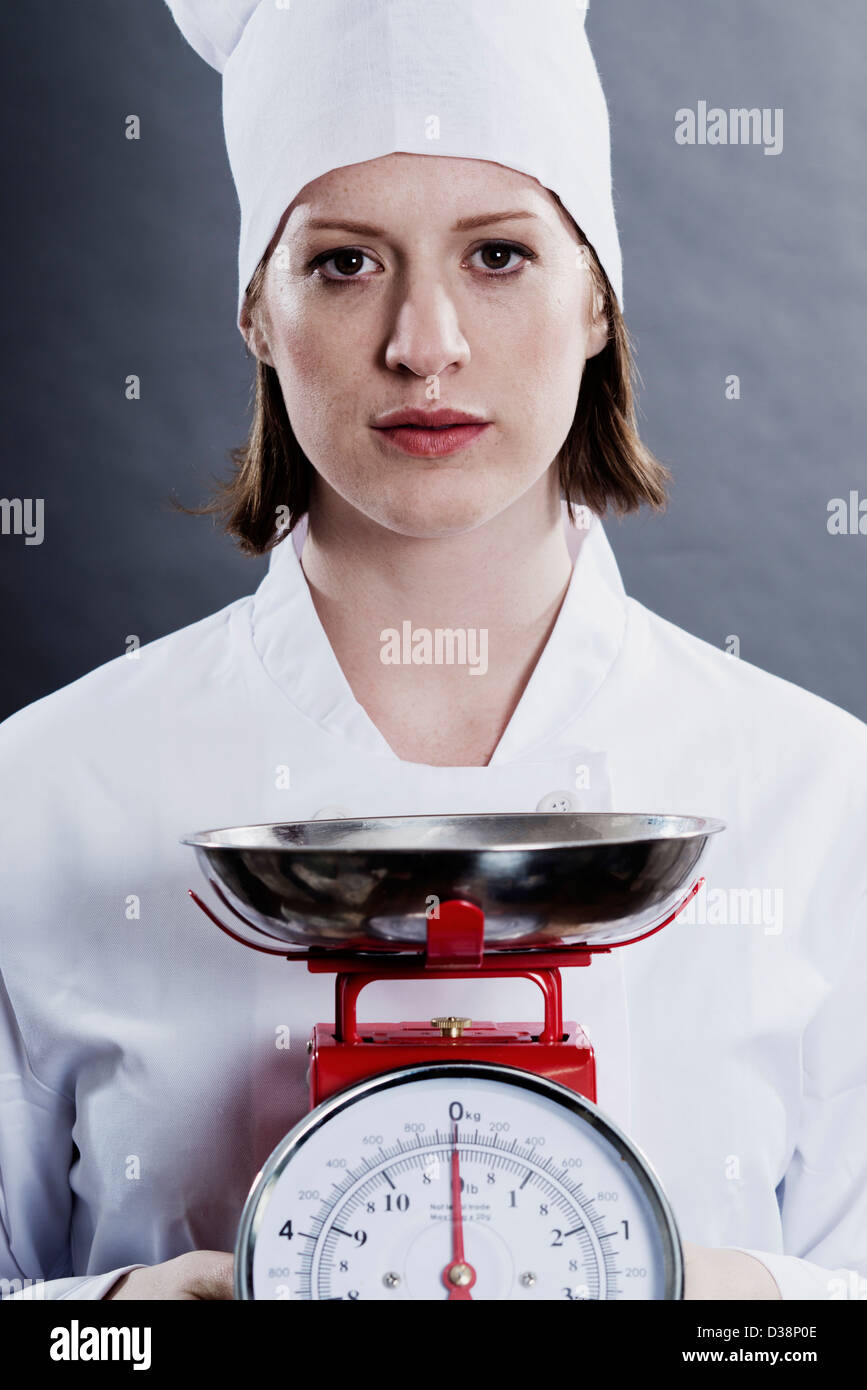 Chef holding kitchen scales Stock Photo - Alamy