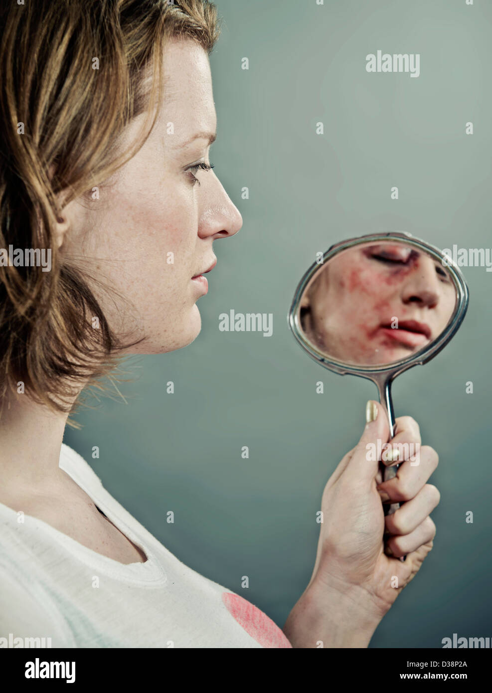 Woman examining her bruised face Stock Photo - Alamy