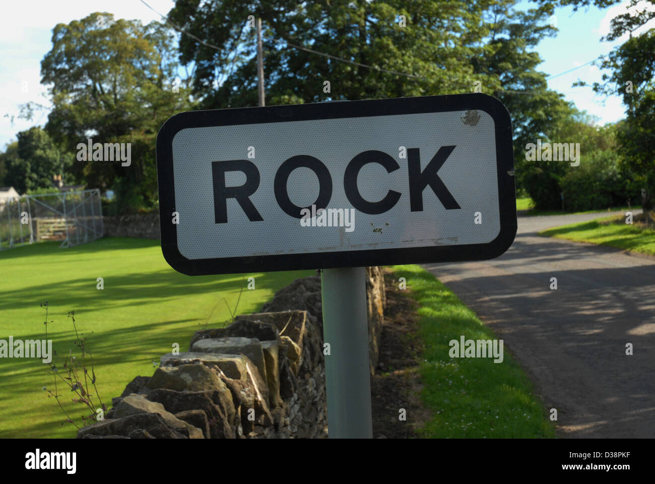 Rock road sign, with green fields in background. England, UK Stock ...