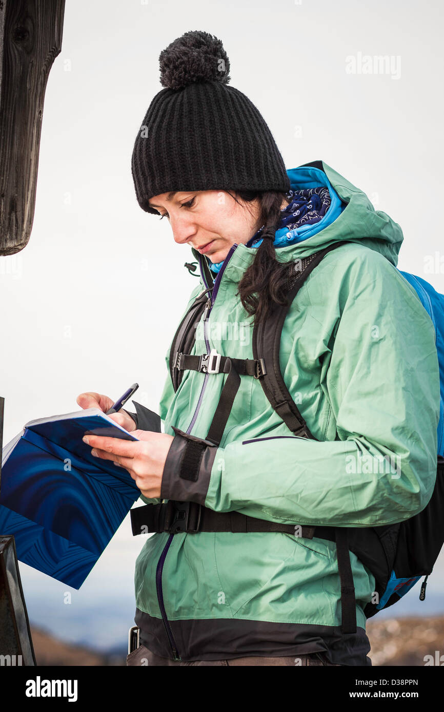 Hiker taking notes in rural landscape Stock Photo - Alamy