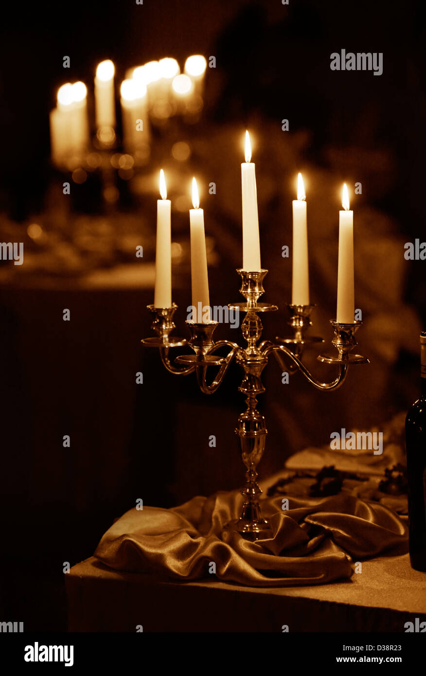 Burning candles in an ancient gold candelabrum Stock Photo - Alamy
