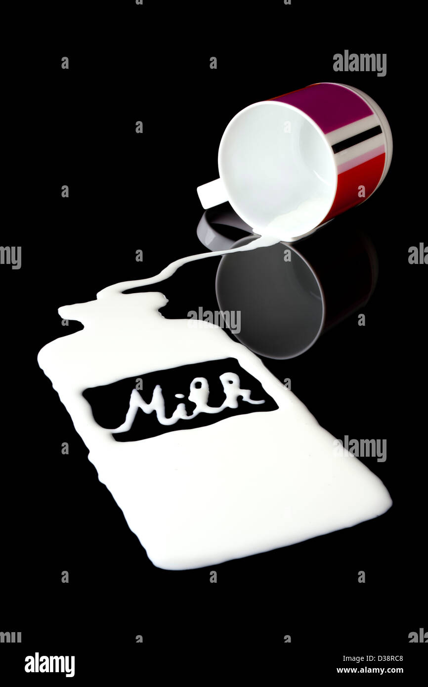 Milk spilling from tilted mug, puddle shaped like a milk bottle, black ...
