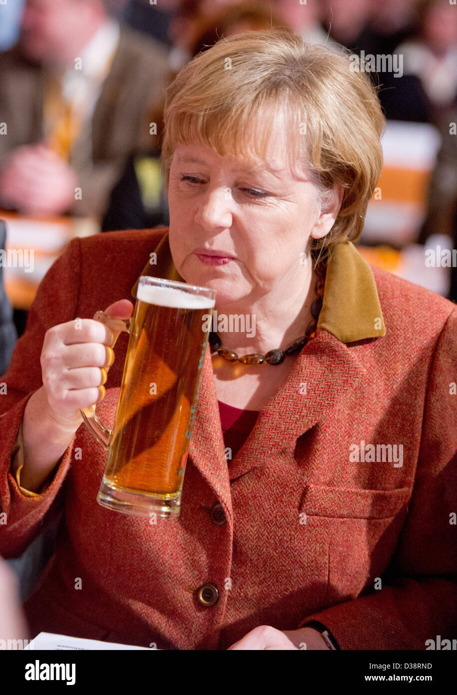 Party leader of the CDU and German Chancellor Angela Merkel drinks from ...