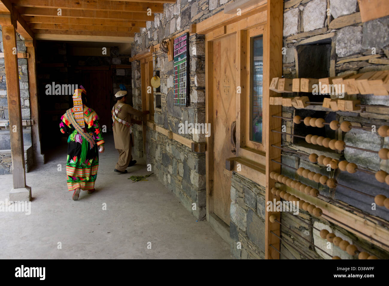 Kalash man and woman outside the school of the Kalasha-dur museum ...