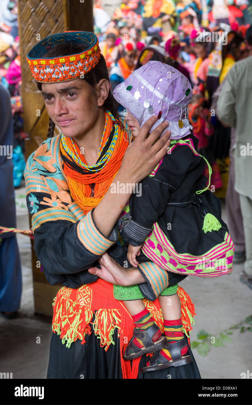 Kalash woman carrying her young daughter at the Kalash Joshi (Spring ...