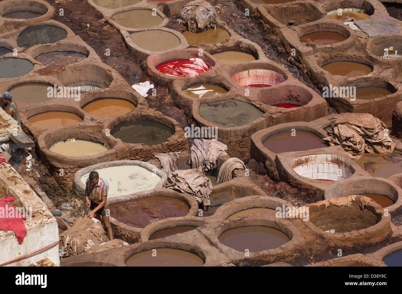 Worker in the dyeing pits of the Chouara Tannery, Fes, Morocco Stock ...