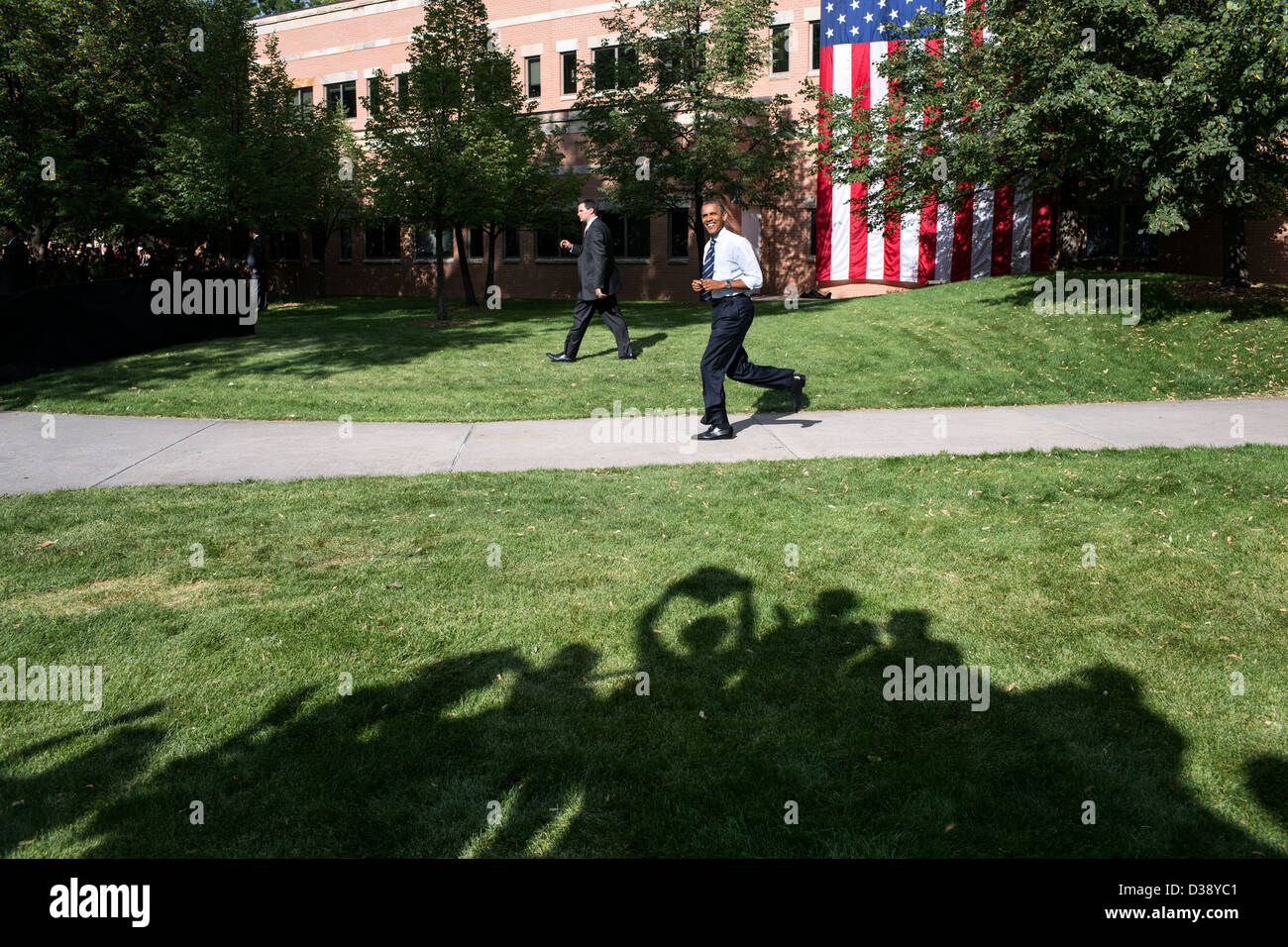 The shadows of supporters are seen cheering as the President makes his ...