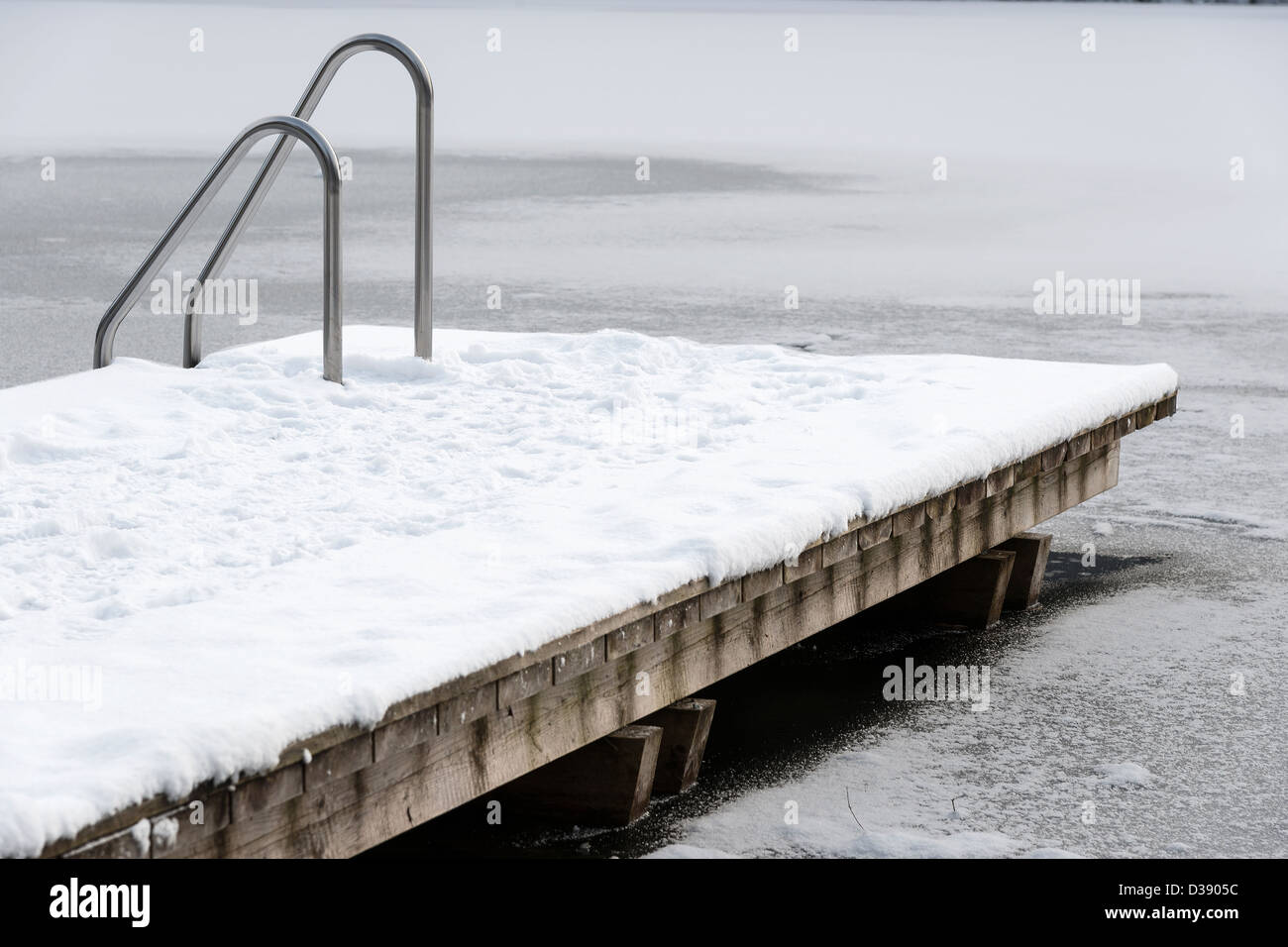 Pool ladder on a frozen lake with snow and ice Stock Photo - Alamy