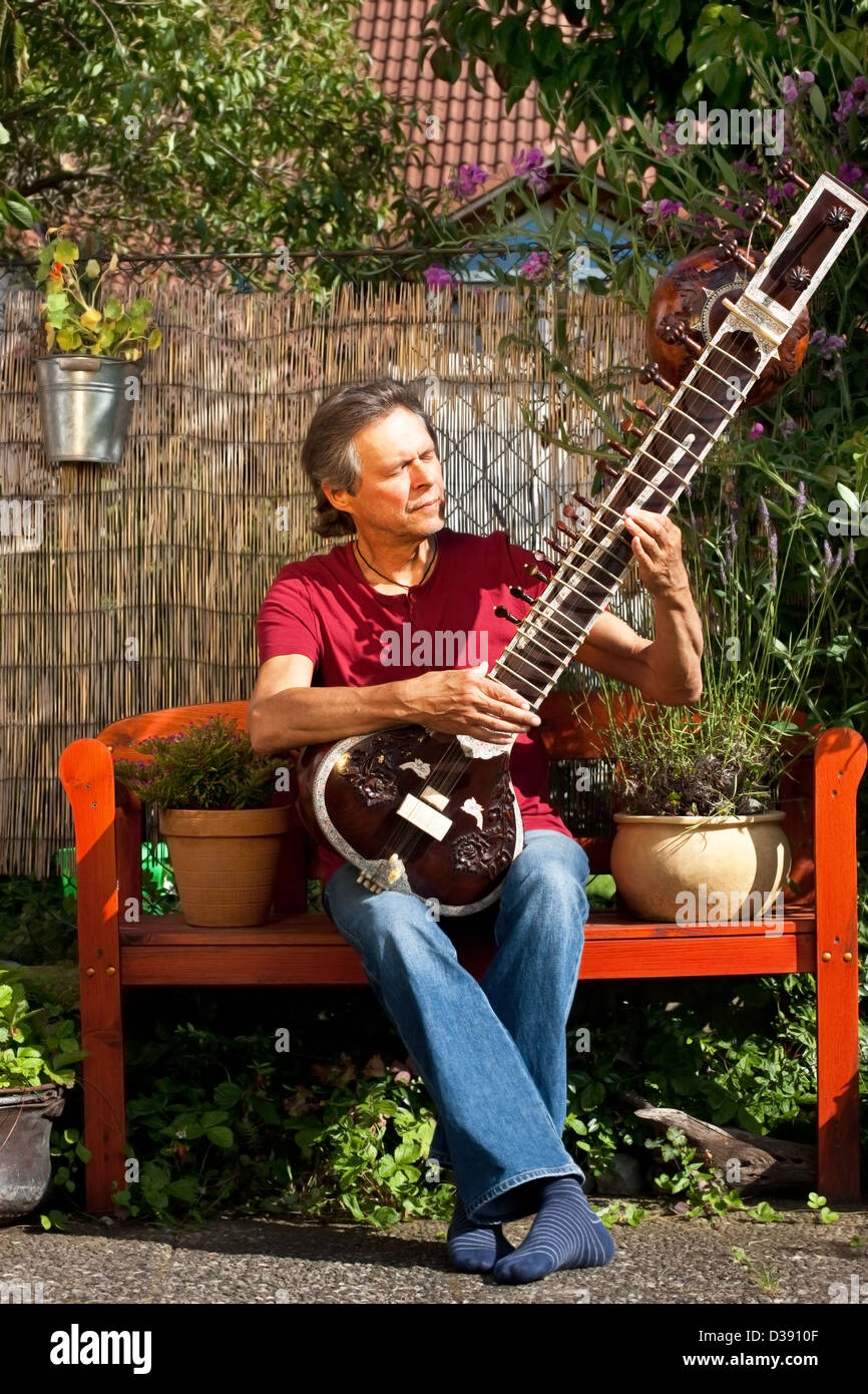 older man is playing a sitar Stock Photo - Alamy