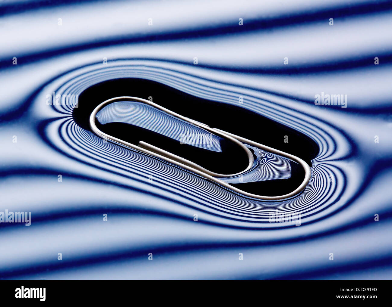 Paperclip floating on water with stripes Stock Photo - Alamy