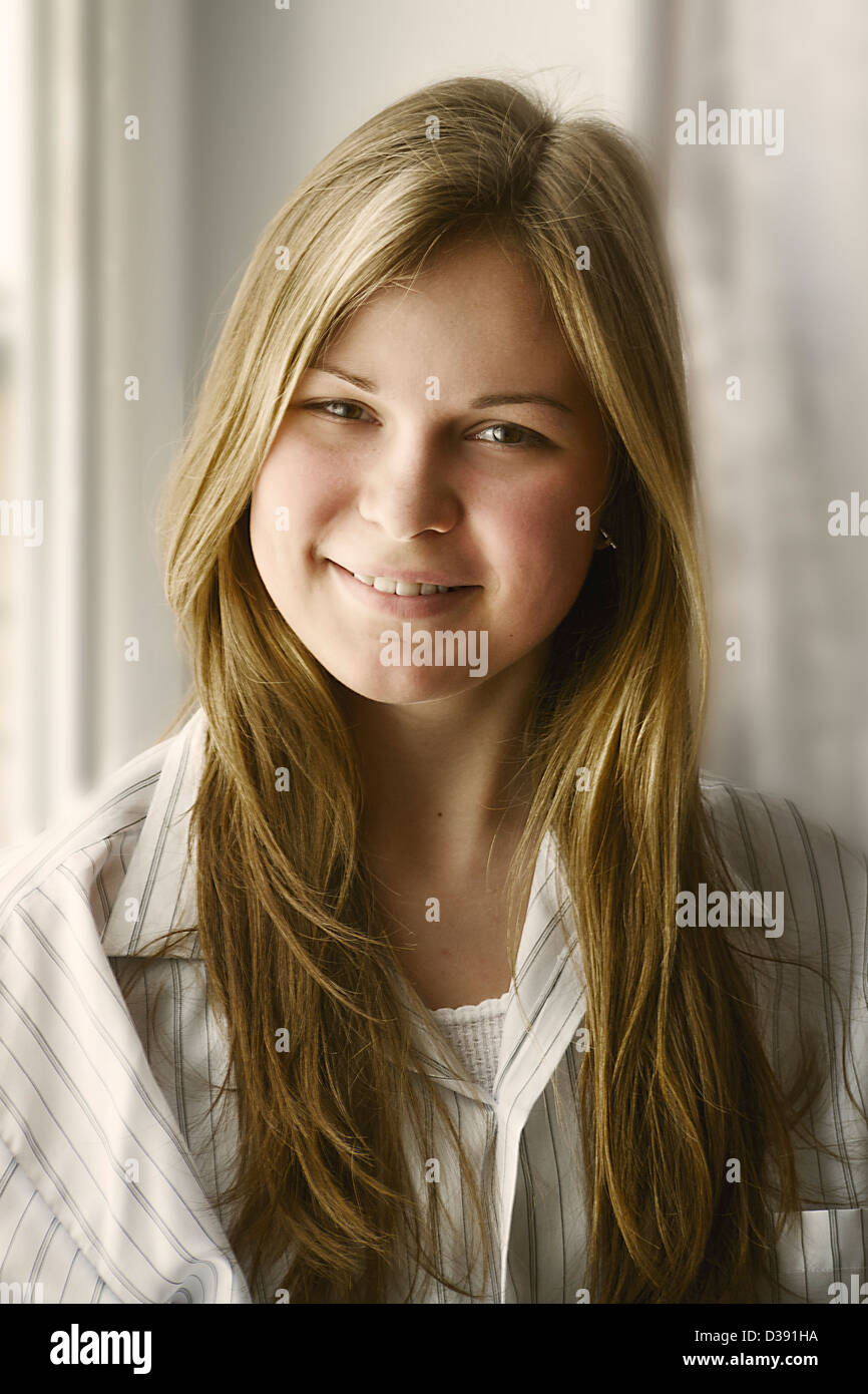 Portrait of a girl in a white shirt in the window Stock Photo - Alamy