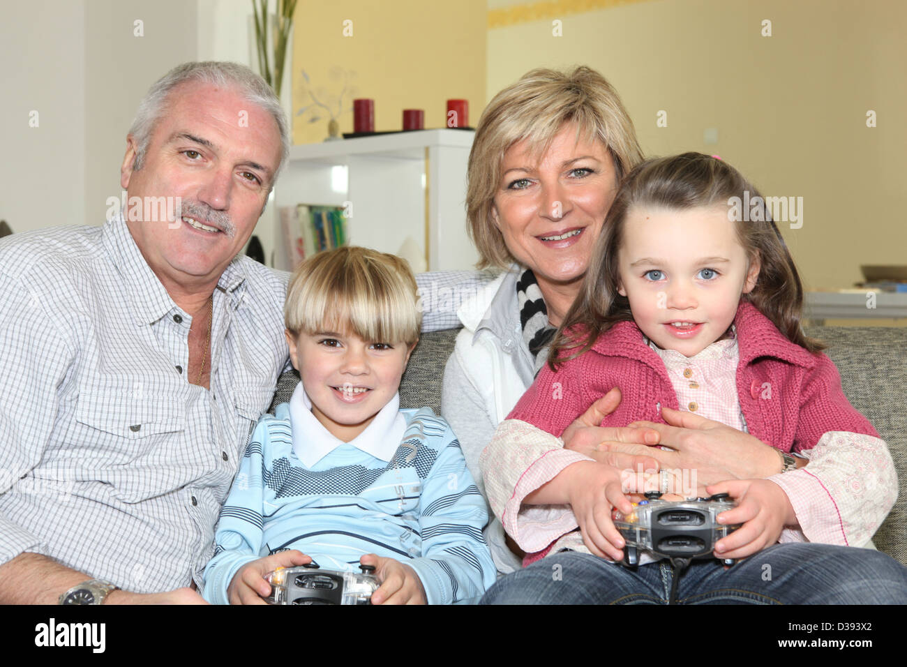 Family playing video-games together Stock Photo - Alamy