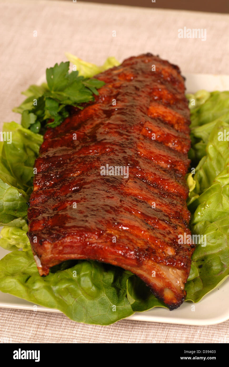 A slab of ribs resting on lettuce Stock Photo - Alamy