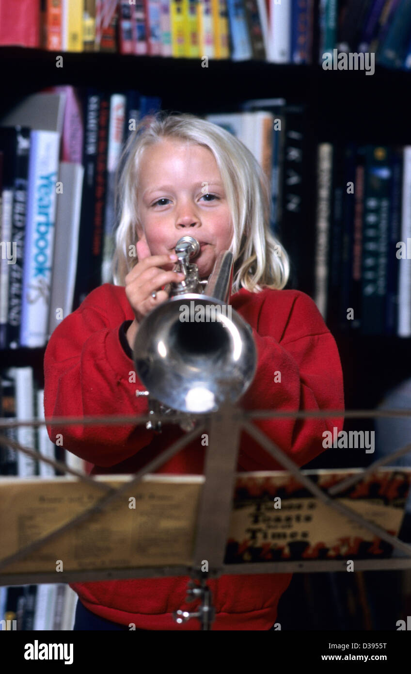 Child at 6 years, learning to play the cornet, musical instrument Stock ...