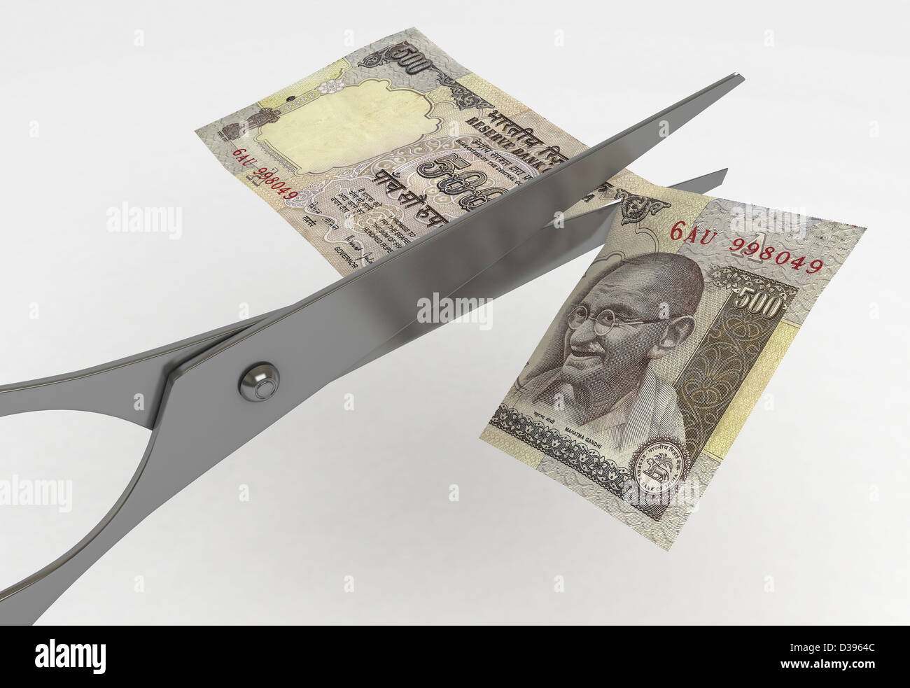 Scissor cutting Indian five hundred Rupee note representing concept of ...