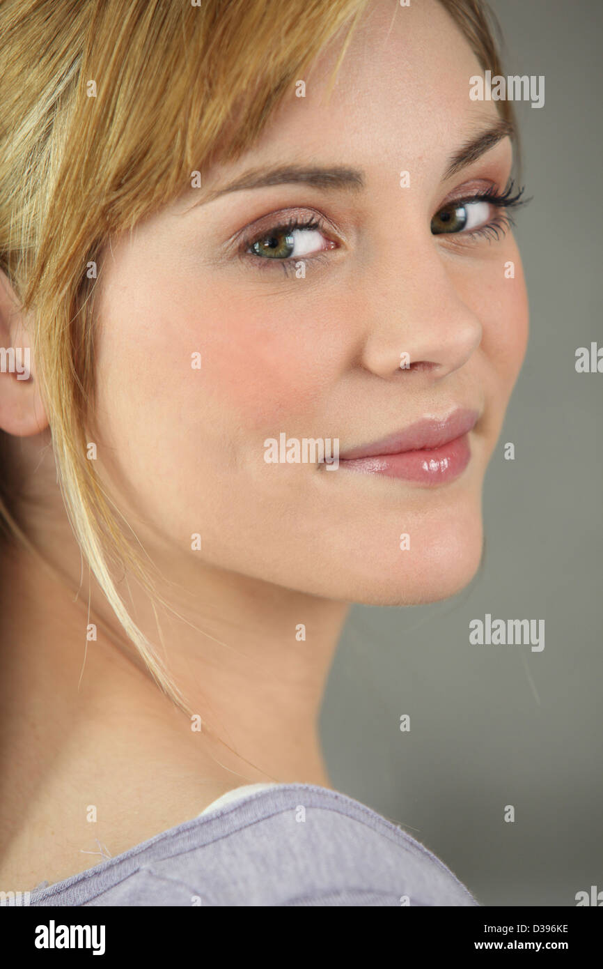 Portrait of a woman looking over her shoulder Stock Photo - Alamy