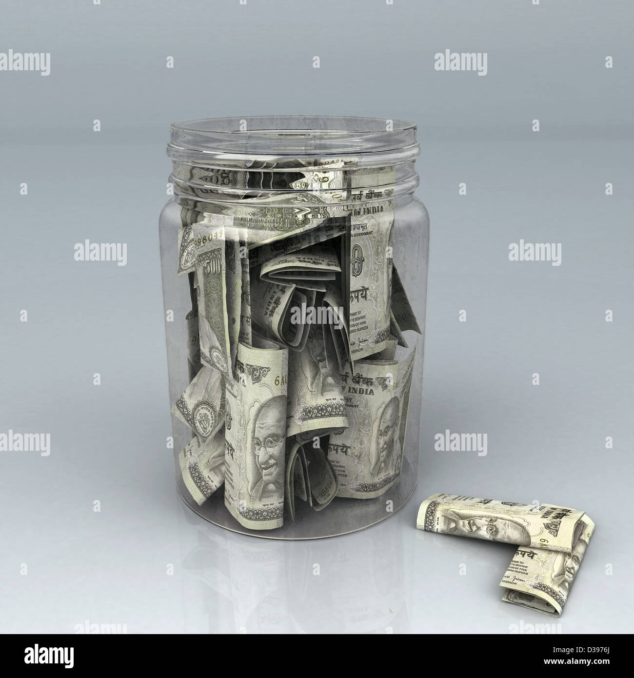 Conceptual shot of Indian paper currency in jar over colored background ...