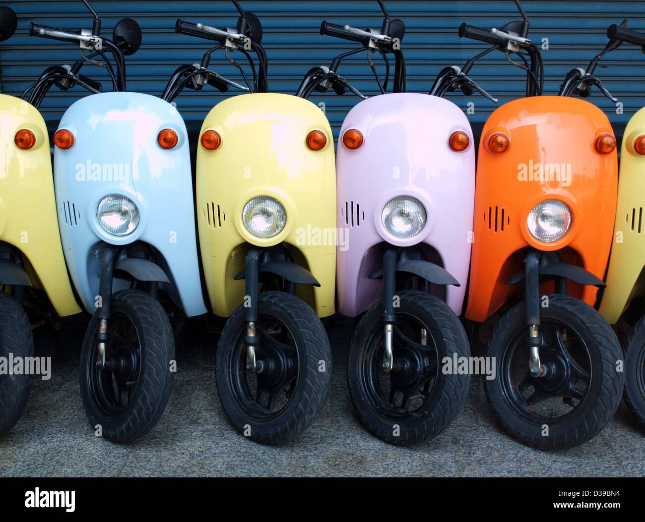 A lineup of rental scooters in bright pastel colors Stock Photo - Alamy