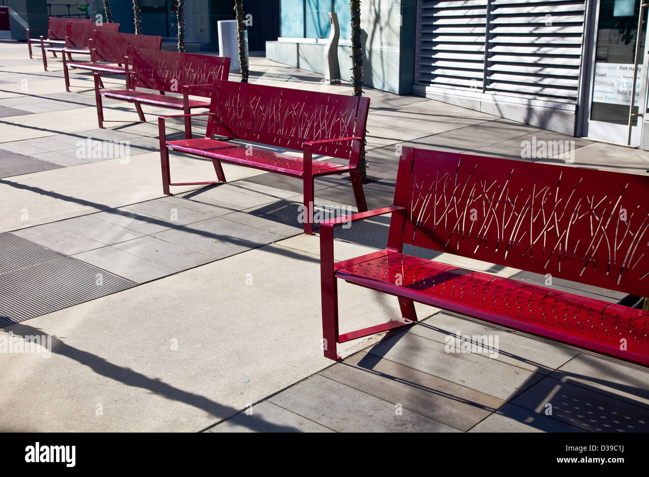 A row of red metallic benches on a street in Vancouver, Canada Stock ...