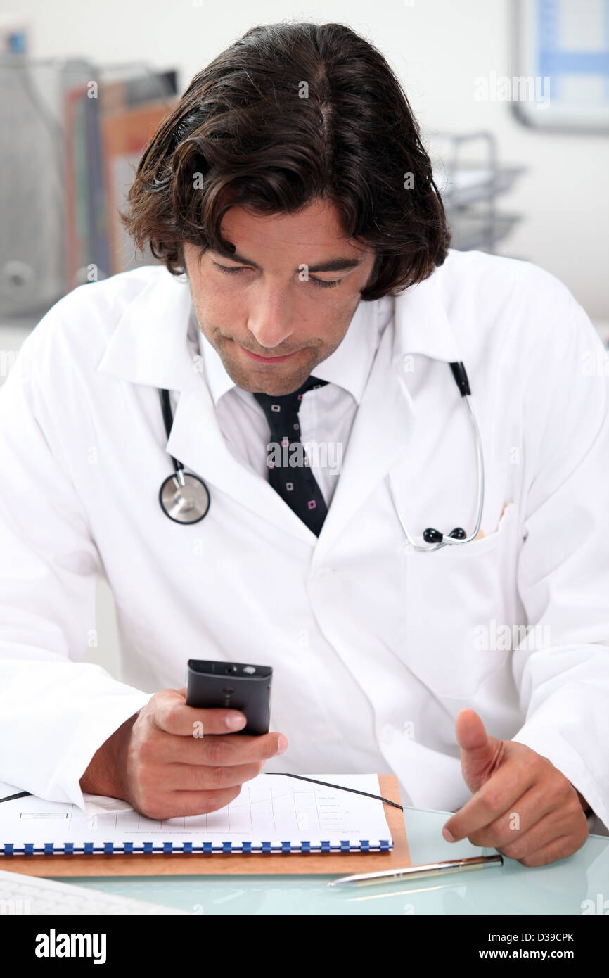 Doctor reading message Stock Photo - Alamy