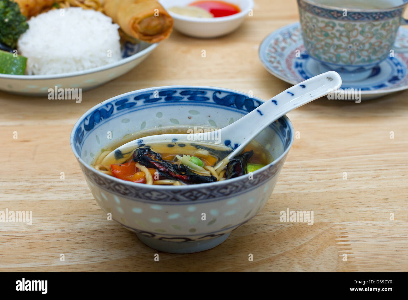 Traditional Chinese food on rice china pattern plates Stock Photo - Alamy