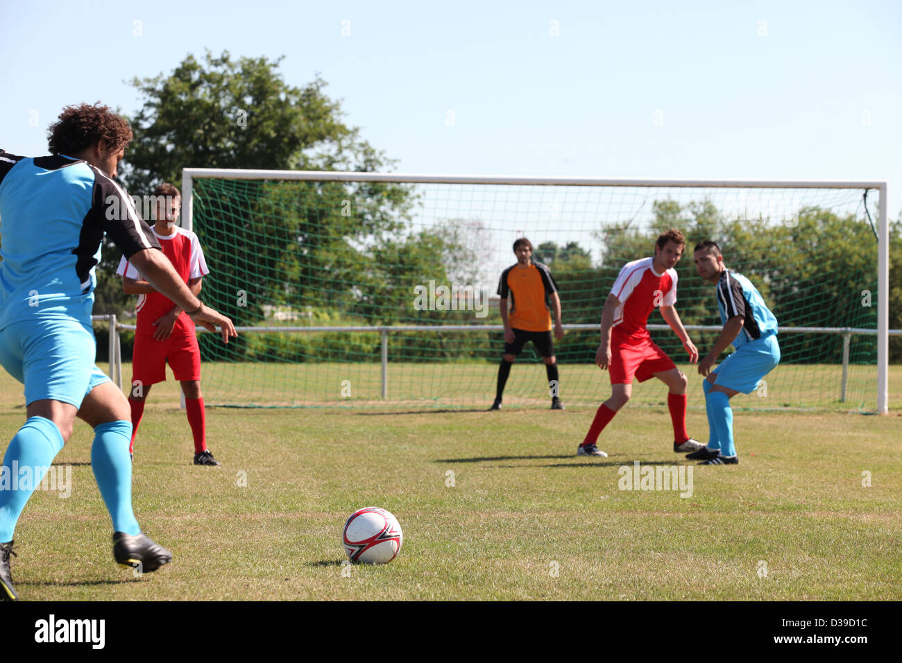 Football player shooting a goal Stock Photo - Alamy
