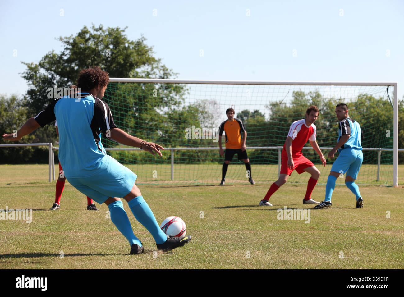 Footballer going for goal Stock Photo - Alamy