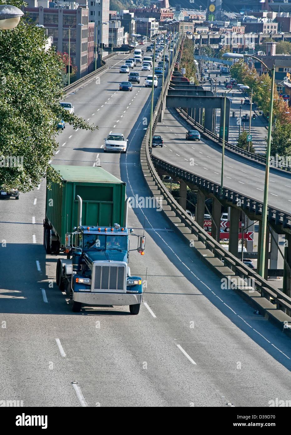 big rig truck hauling a load on a busy freeway in an American city ...