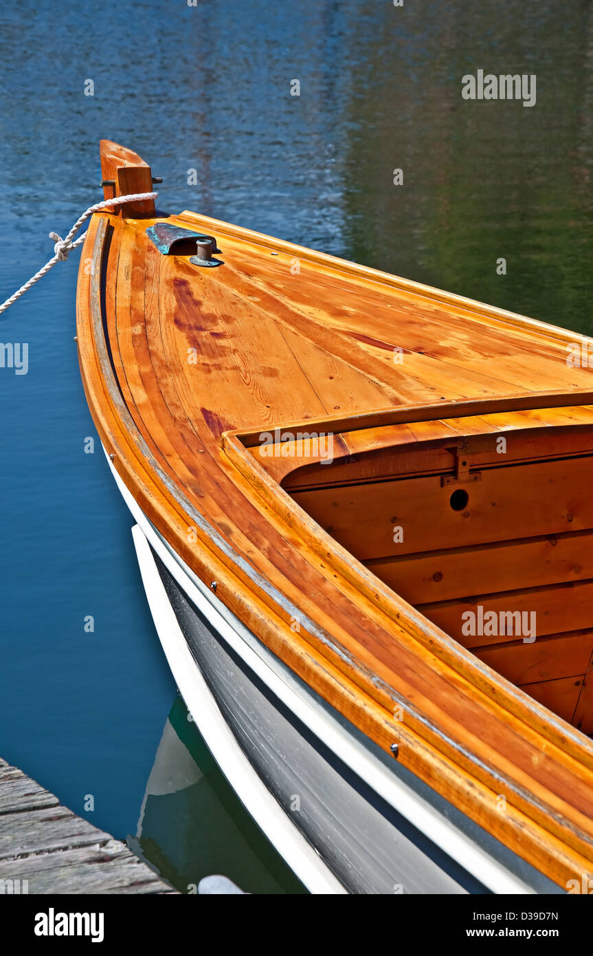 This is a wooden small boat stern, that is tied to a dock with fairly ...
