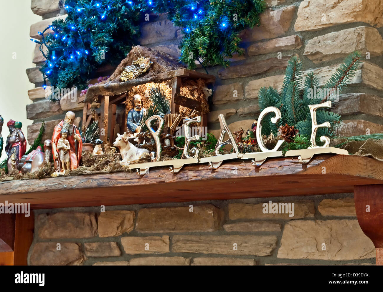 This Christmas still life is on a rock fireplace mantle with the word ...