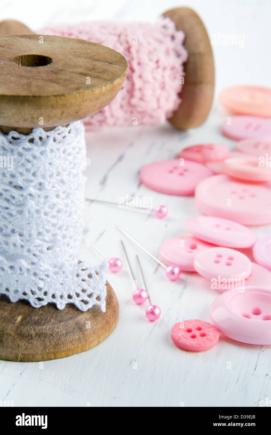 Sewing background with pink buttons and white lace Stock Photo - Alamy