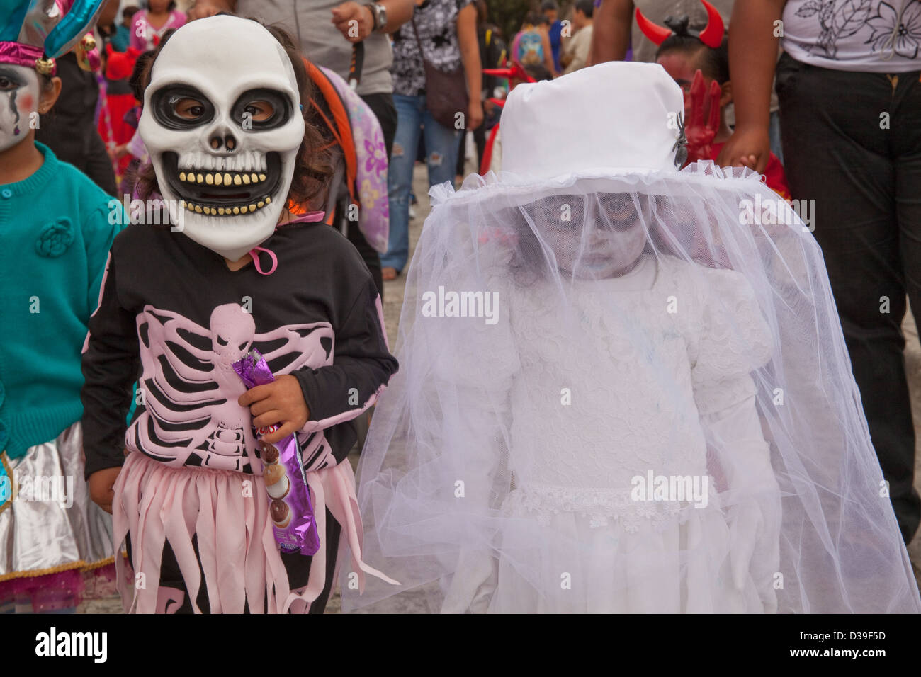 Young girls dressed as skeleton and ghoulish bride for Day of the Dead ...