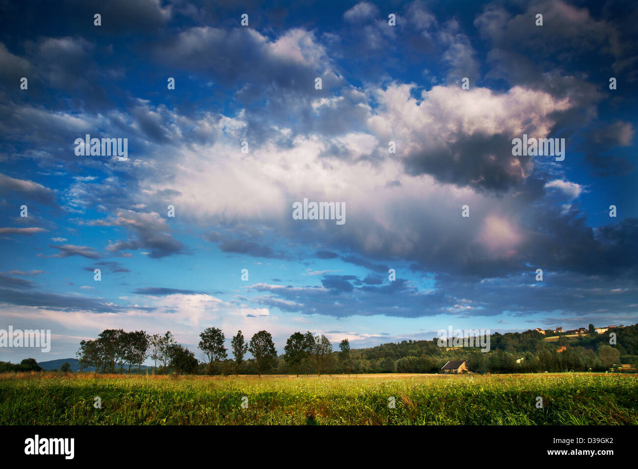 countryside landscape with blue sky, clouds and meadows Stock Photo - Alamy