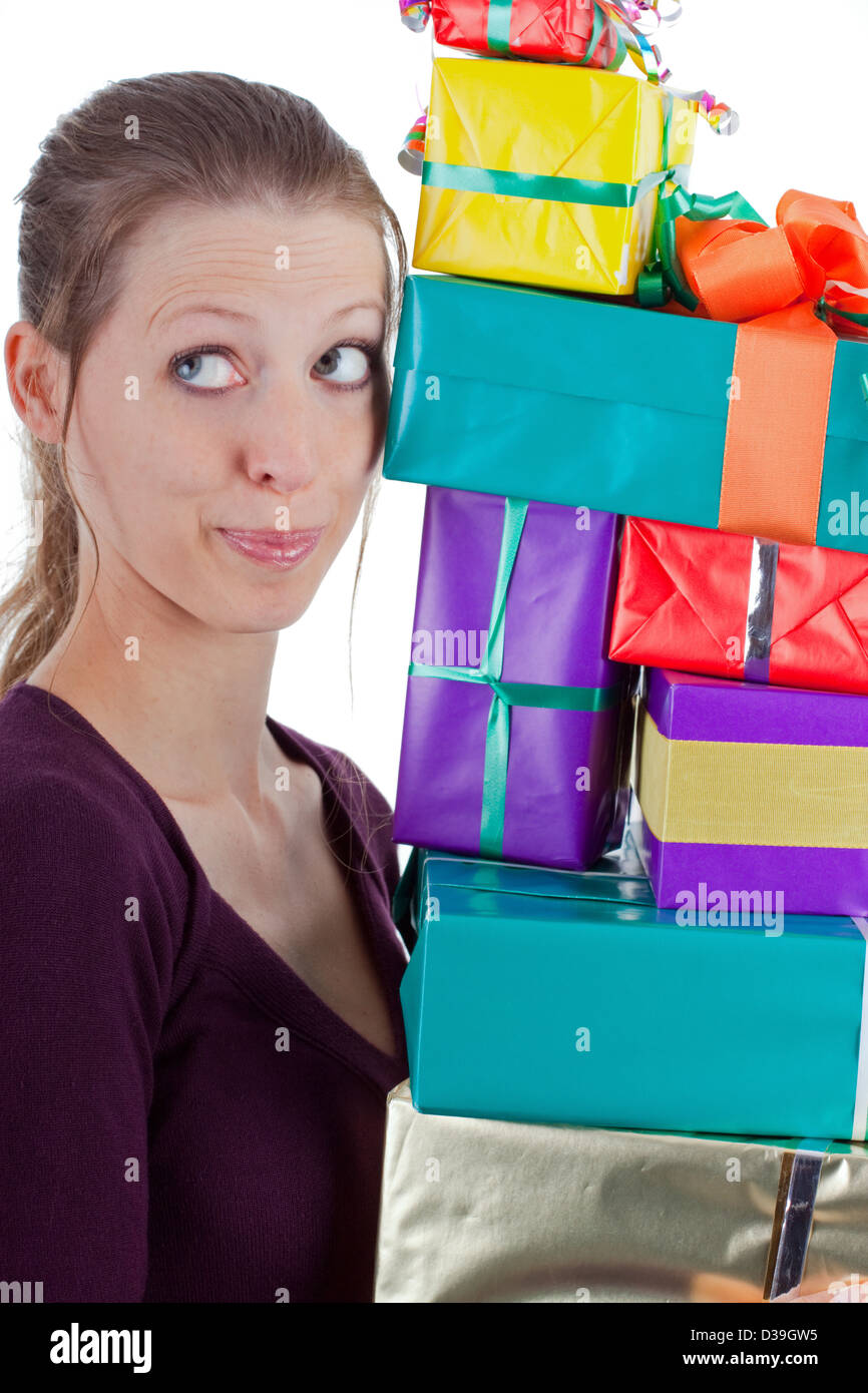 pretty young woman carrying a stack of gifts Stock Photo - Alamy