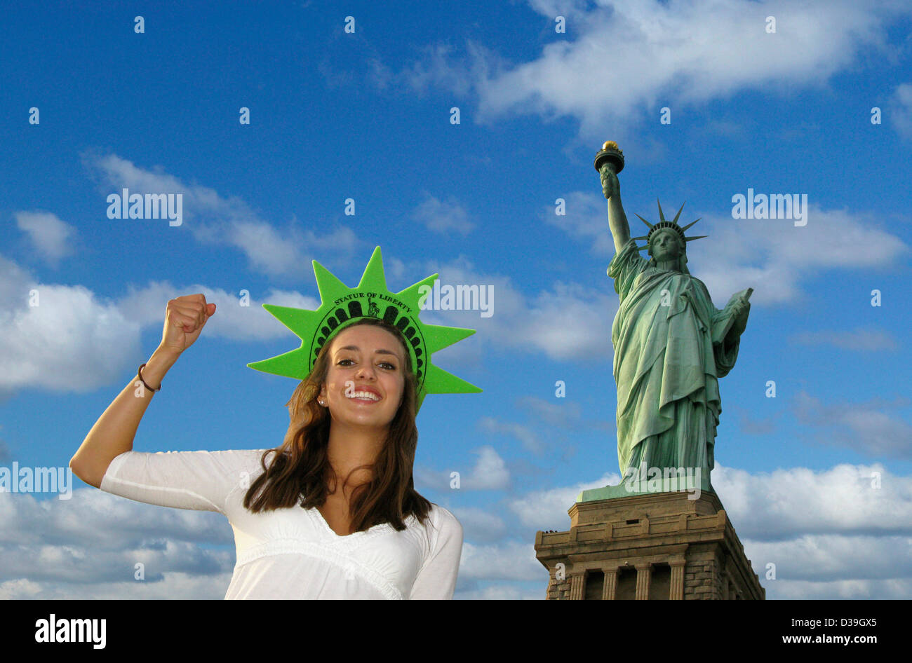 Girl tourist posing on liberty island with statue of liberty in ...
