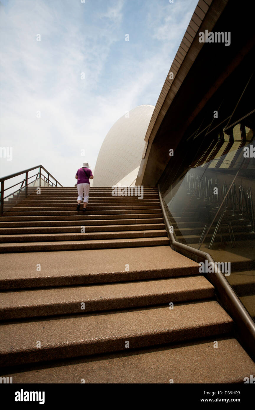 A man climbing the stone stairs outside The Sydney Opera House ...