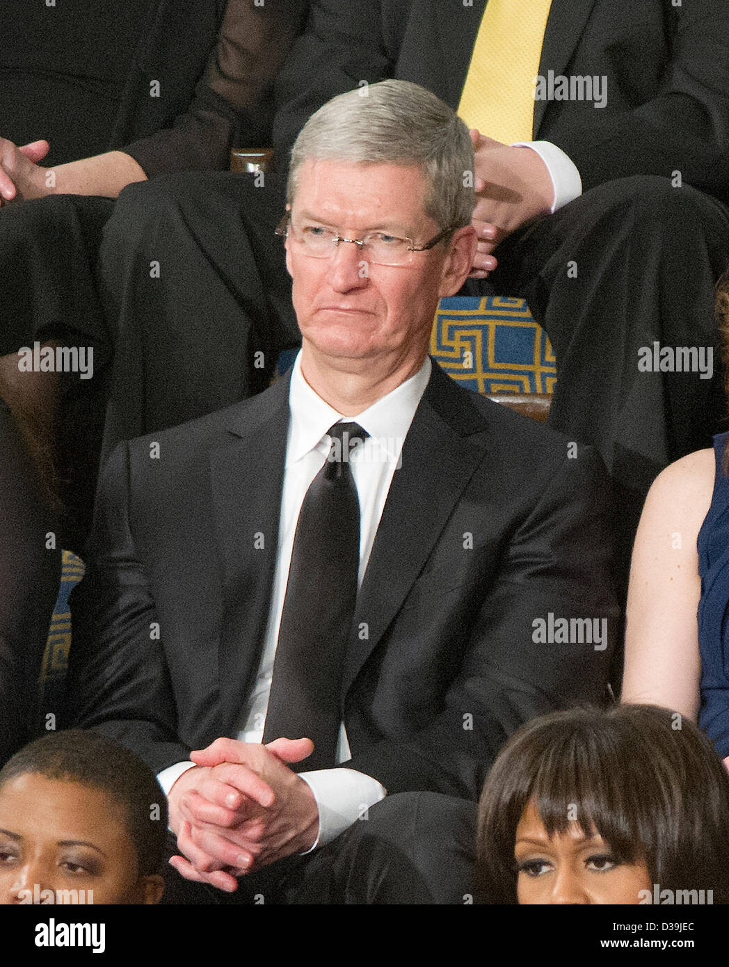 Tim Cook, CEO, Apple, Inc., listens as United States President Barack ...