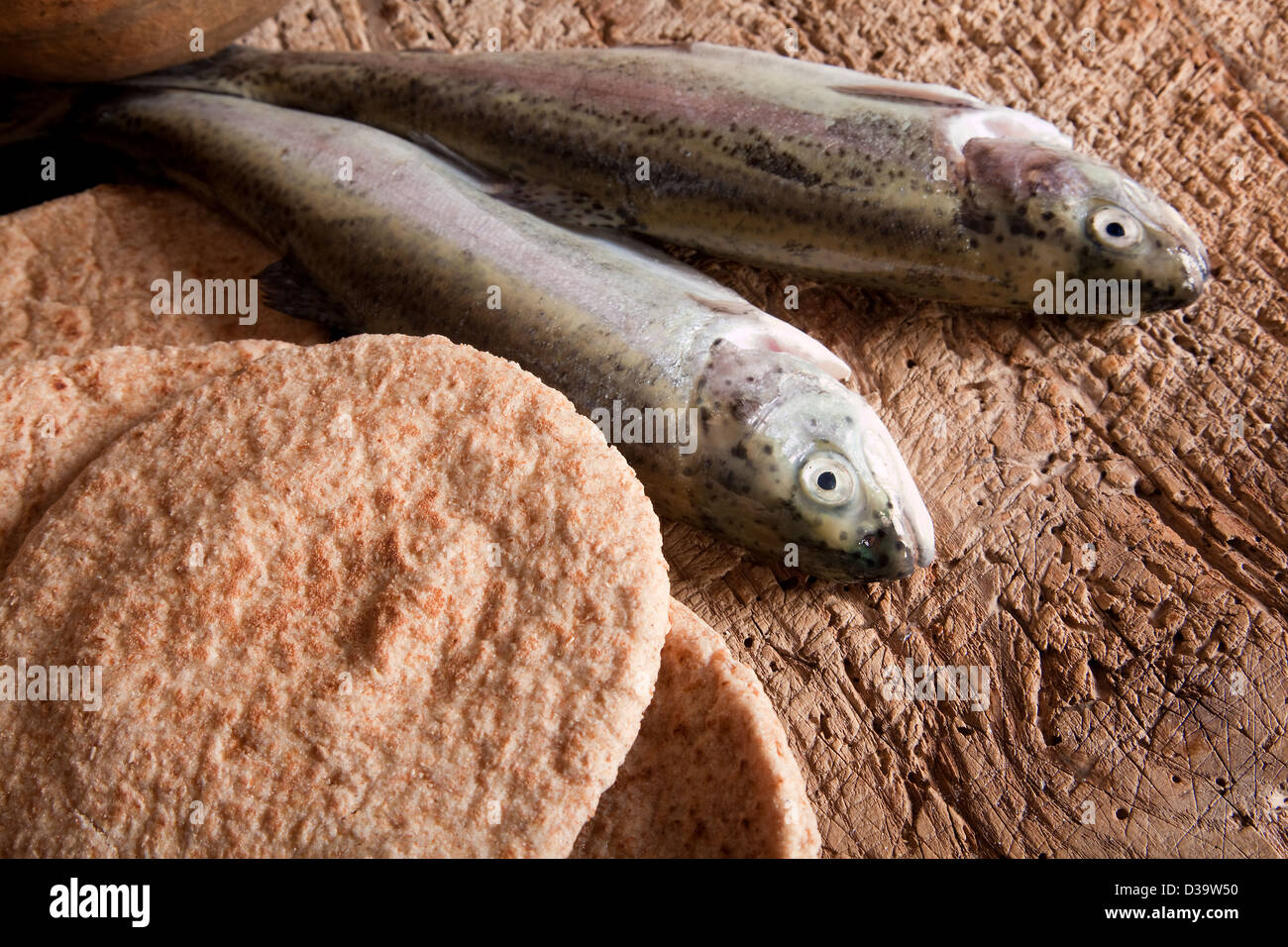 Still life of five loaves of bread and two fresh fish Stock Photo - Alamy
