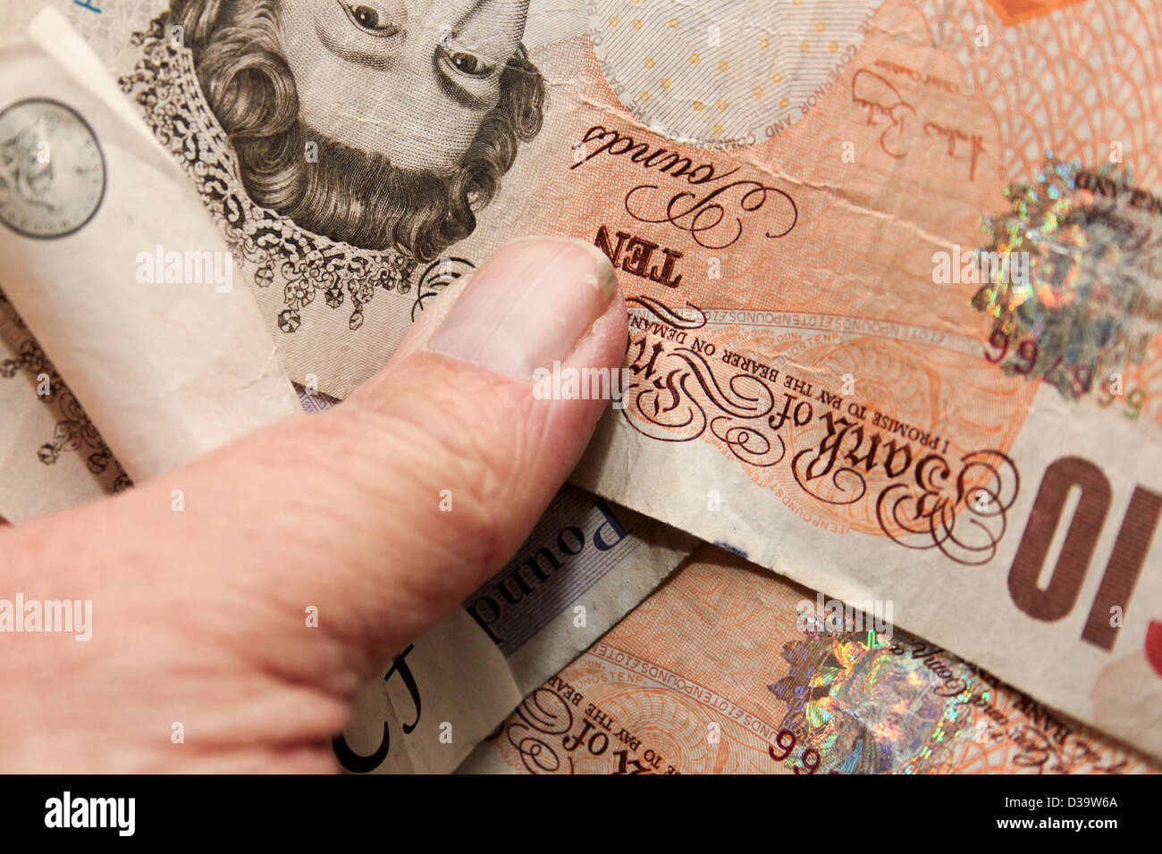 thumb holding british pound notes Stock Photo - Alamy