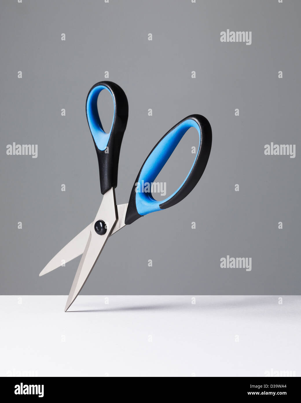 scissors on a white table with a grey background Stock Photo - Alamy