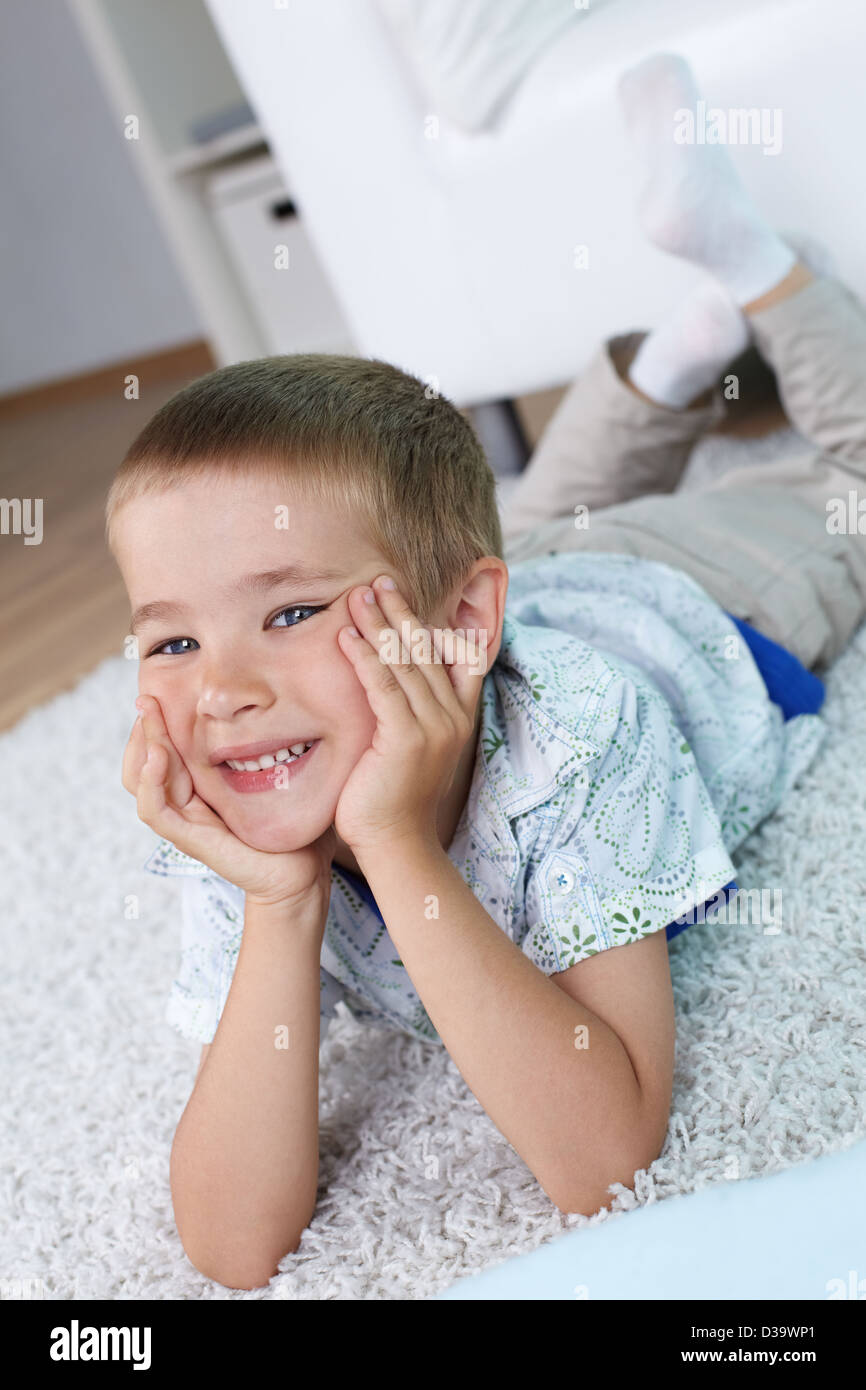 Adorable child lying on the floor and having rest Stock Photo - Alamy
