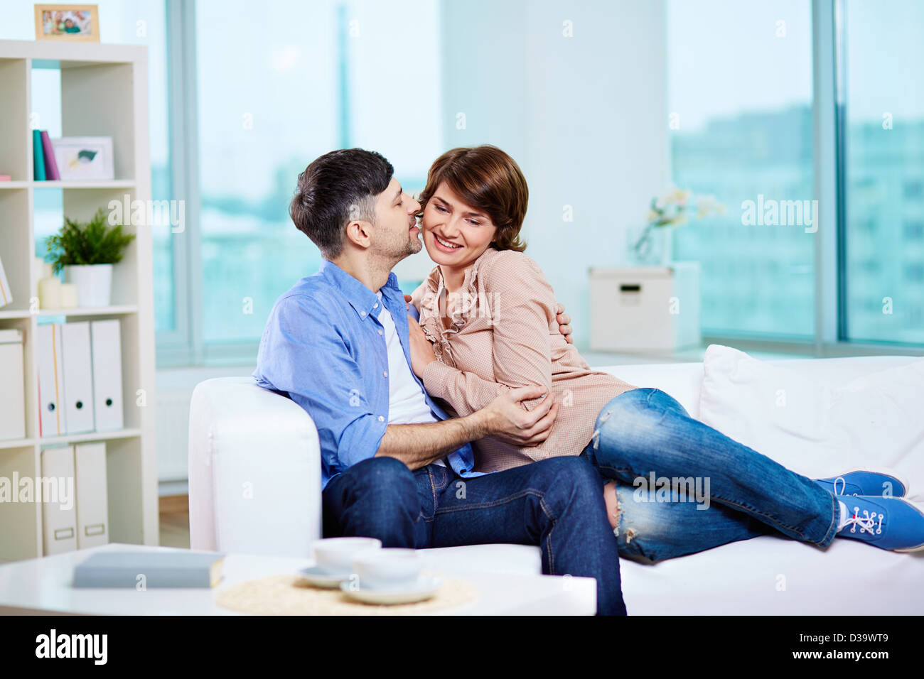 Couple flirting on sofa hi-res stock photography and images - Alamy