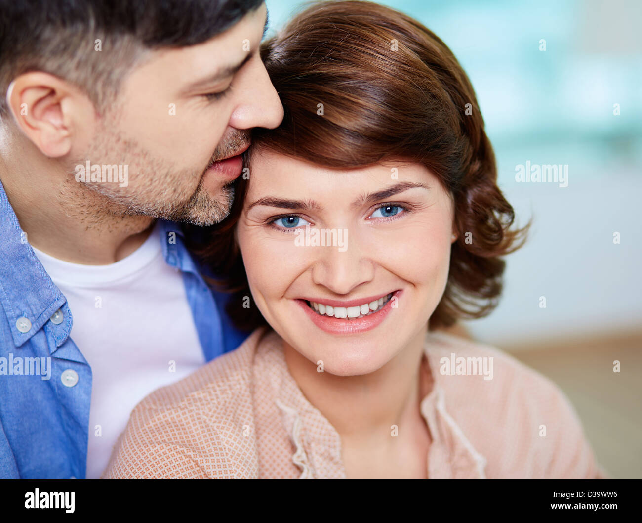 Portrait of middle aged woman looking at camera with her husband near ...