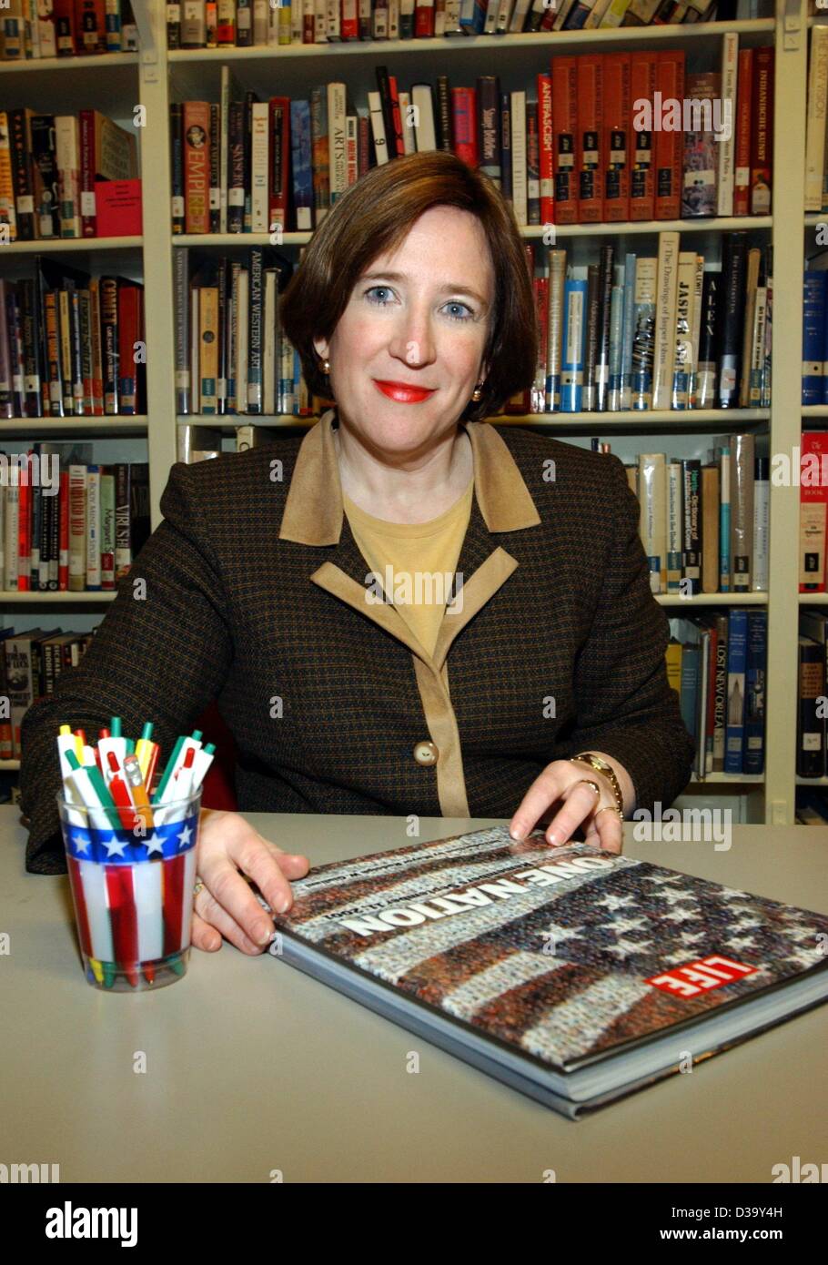US consul general Susan Elbow sits at a table in front of a book at the ...