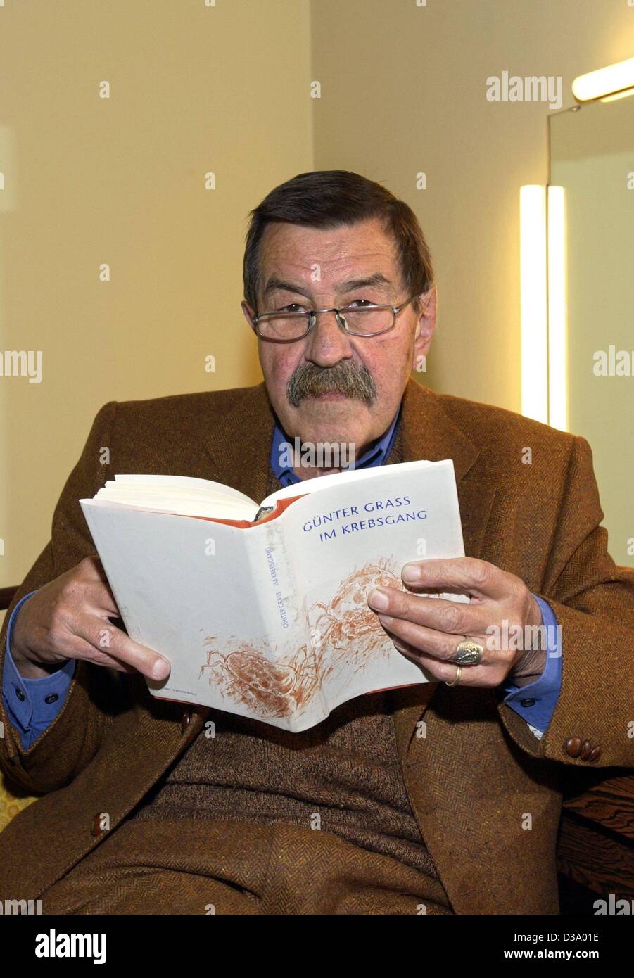 German author Guenter Grass is holding his book 'Im Krebsgang' (In ...