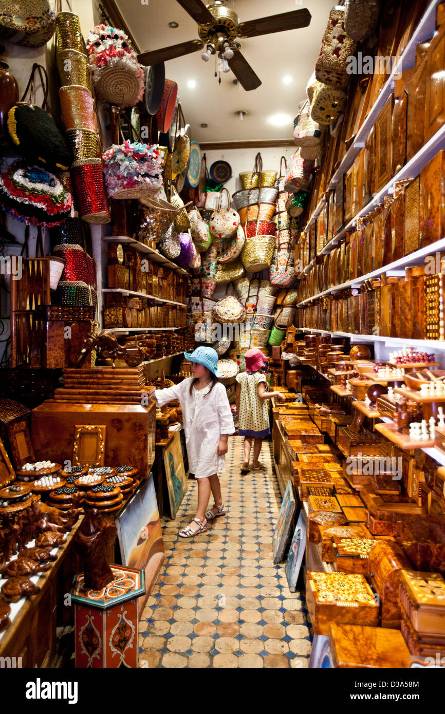 Children looking at souvenirs in Souk, Marrakech, Morocco Stock Photo ...
