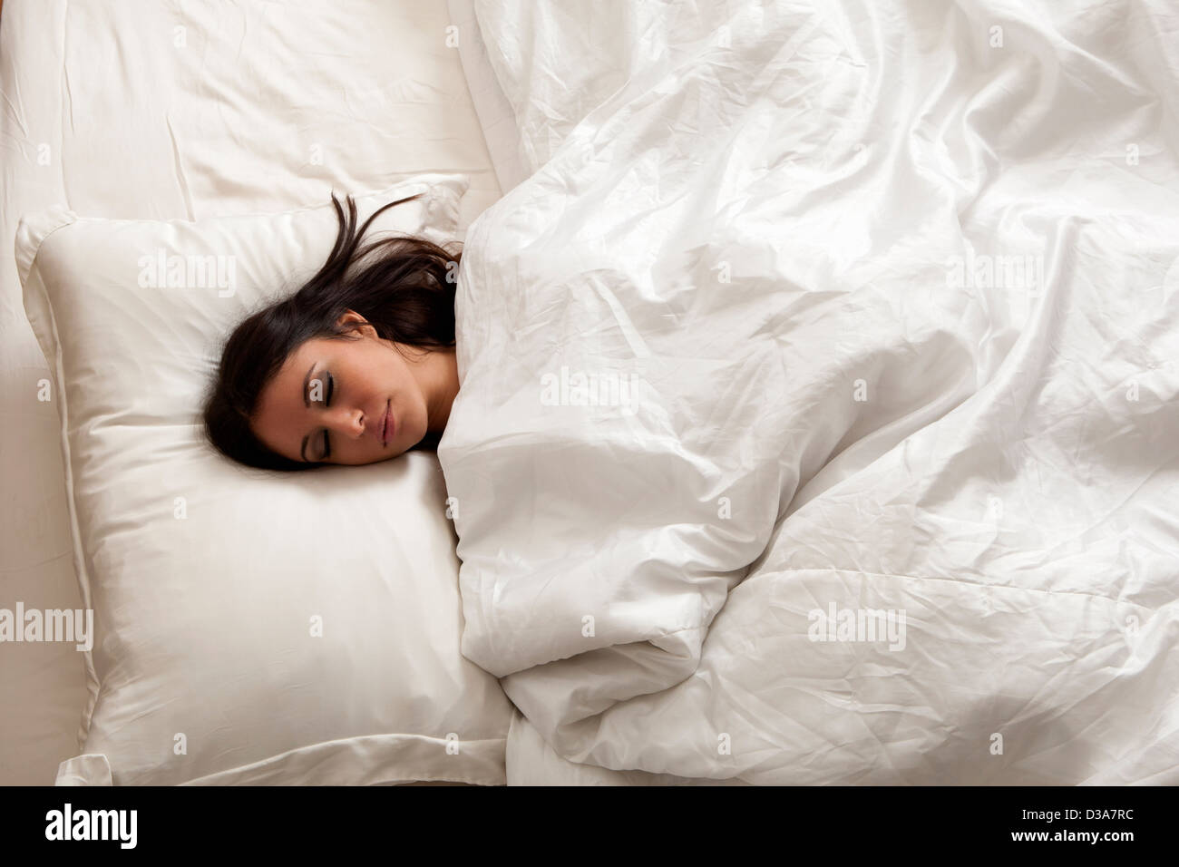 Woman sleeping in bed Stock Photo - Alamy