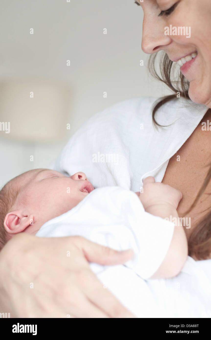 Mother cradling infant son Stock Photo - Alamy